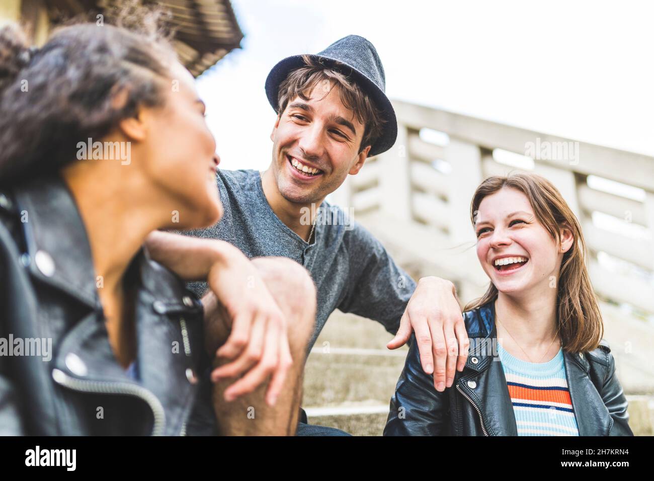 Happy friends talking to each other at park Stock Photo - Alamy