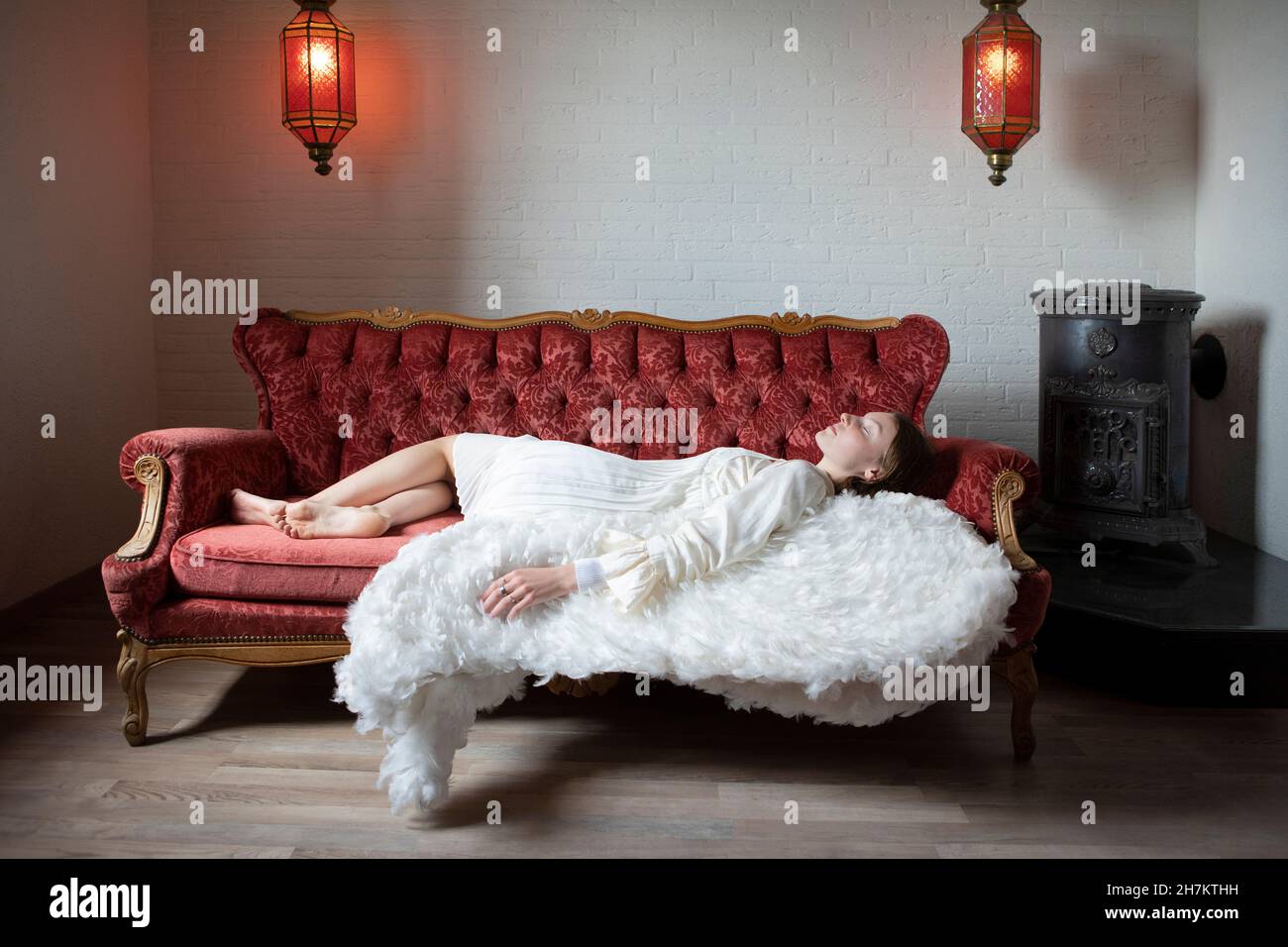 Angel sleeping on sofa in living room Stock Photo - Alamy