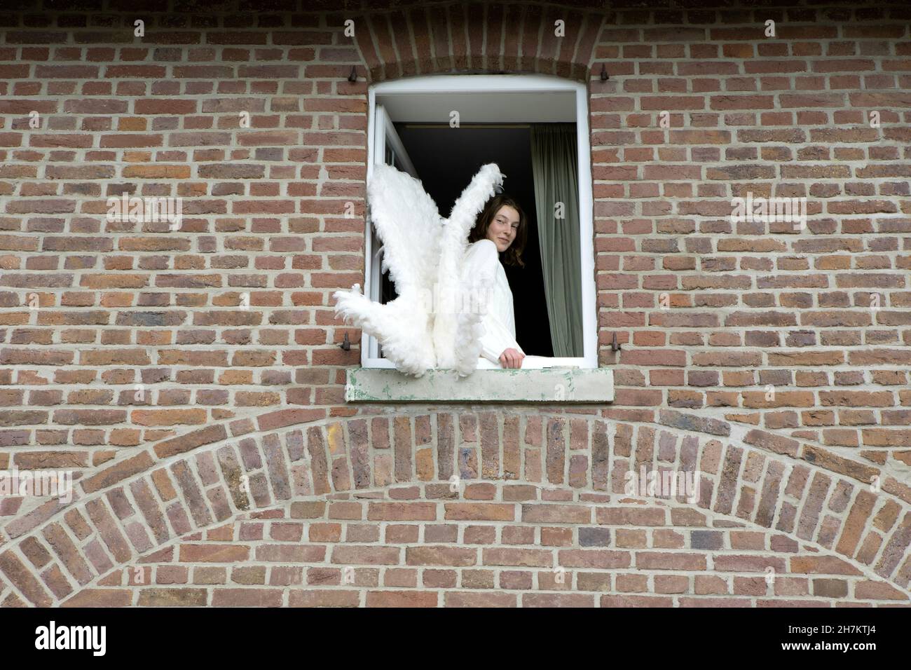 Angel smiling on window sill Stock Photo - Alamy