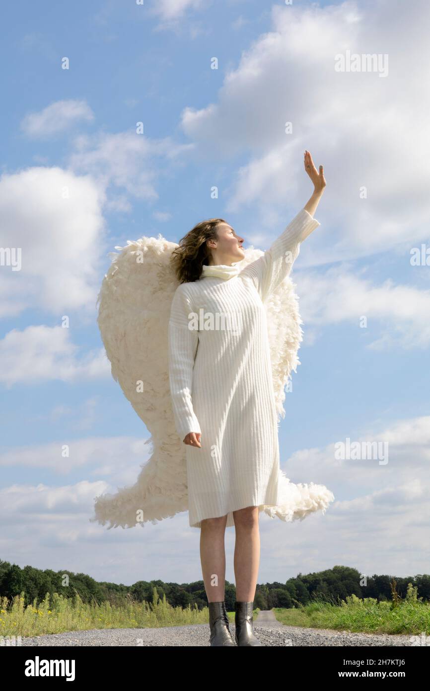 Angel with hand raised on road Stock Photo - Alamy