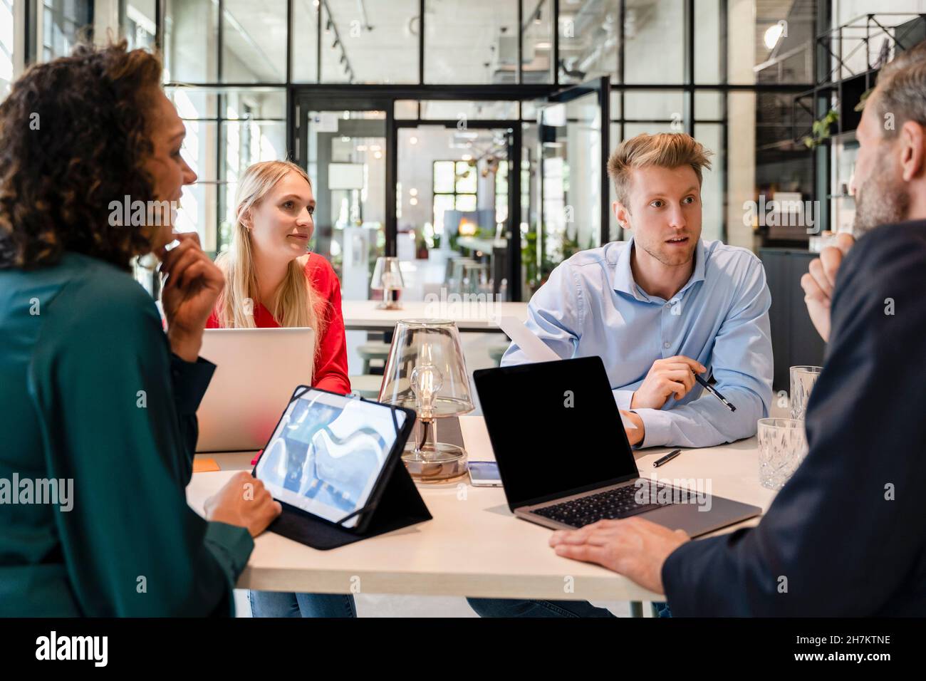 Employees having discussion in office meeting Stock Photo - Alamy