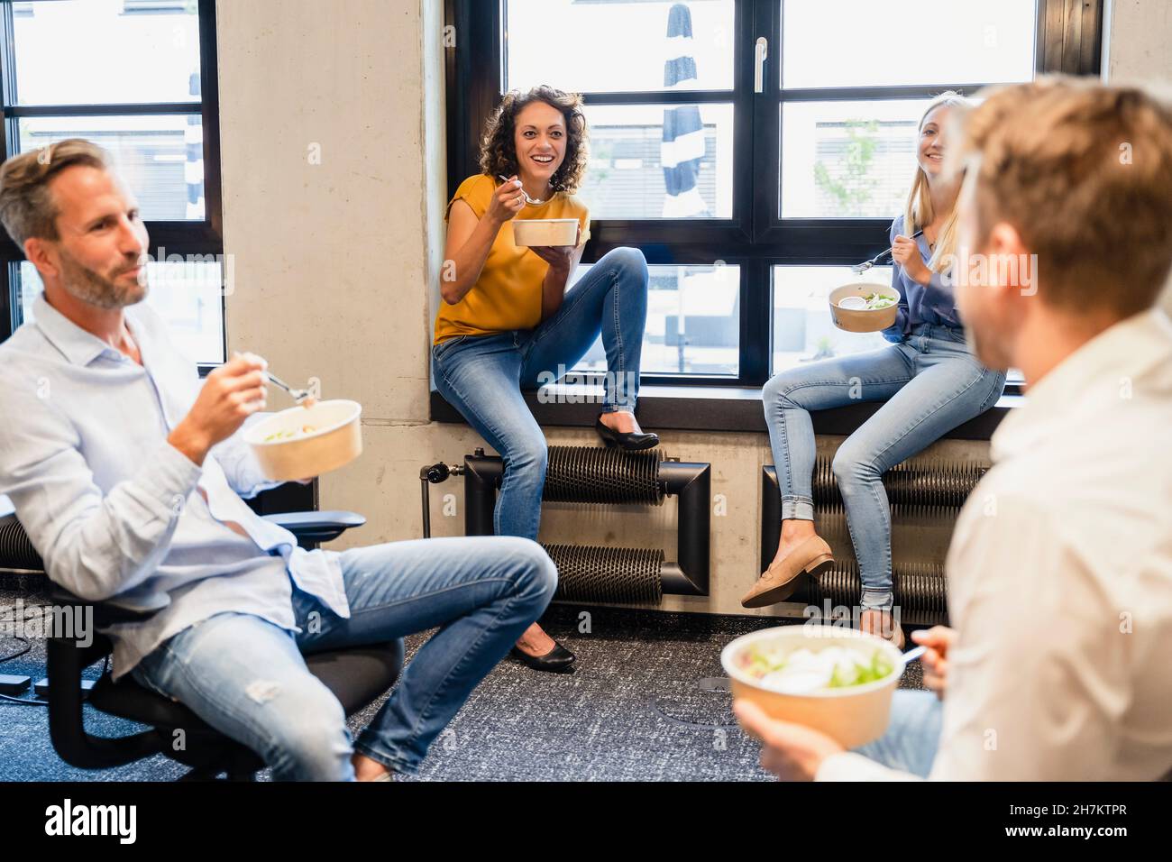 Coworkers having lunch break at workplace Stock Photo - Alamy