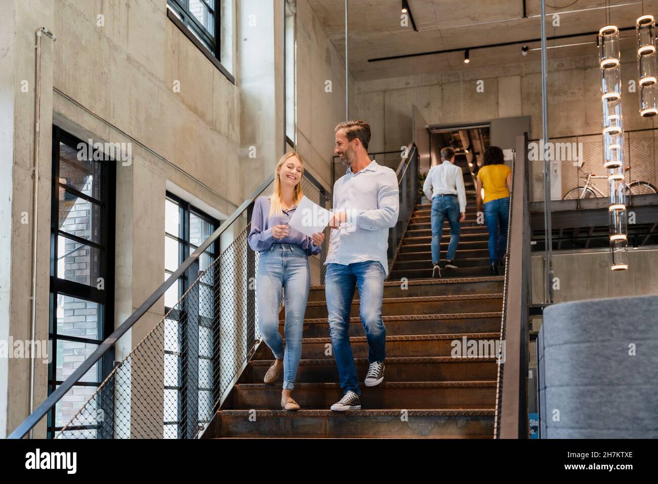 People descending staircase hi-res stock photography and images - Alamy