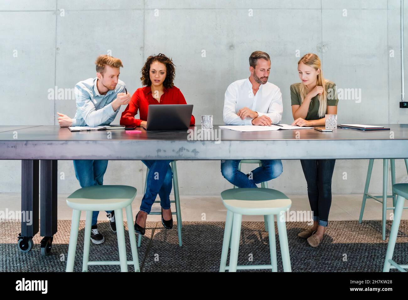 Colleague team working at conference table Stock Photo - Alamy