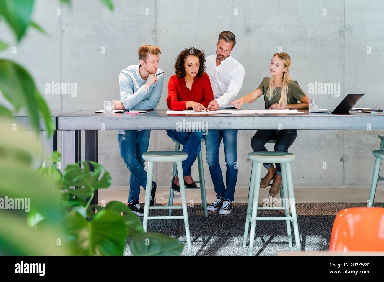 Employees discussing over plan in meeting Stock Photo - Alamy