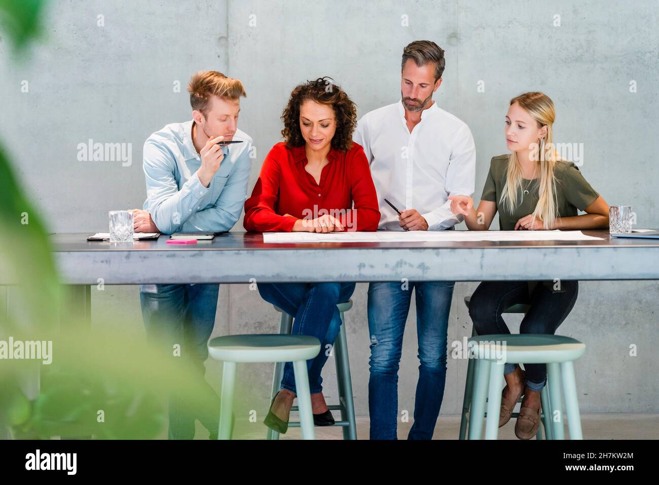 Employees having discussion over plan in meeting Stock Photo - Alamy
