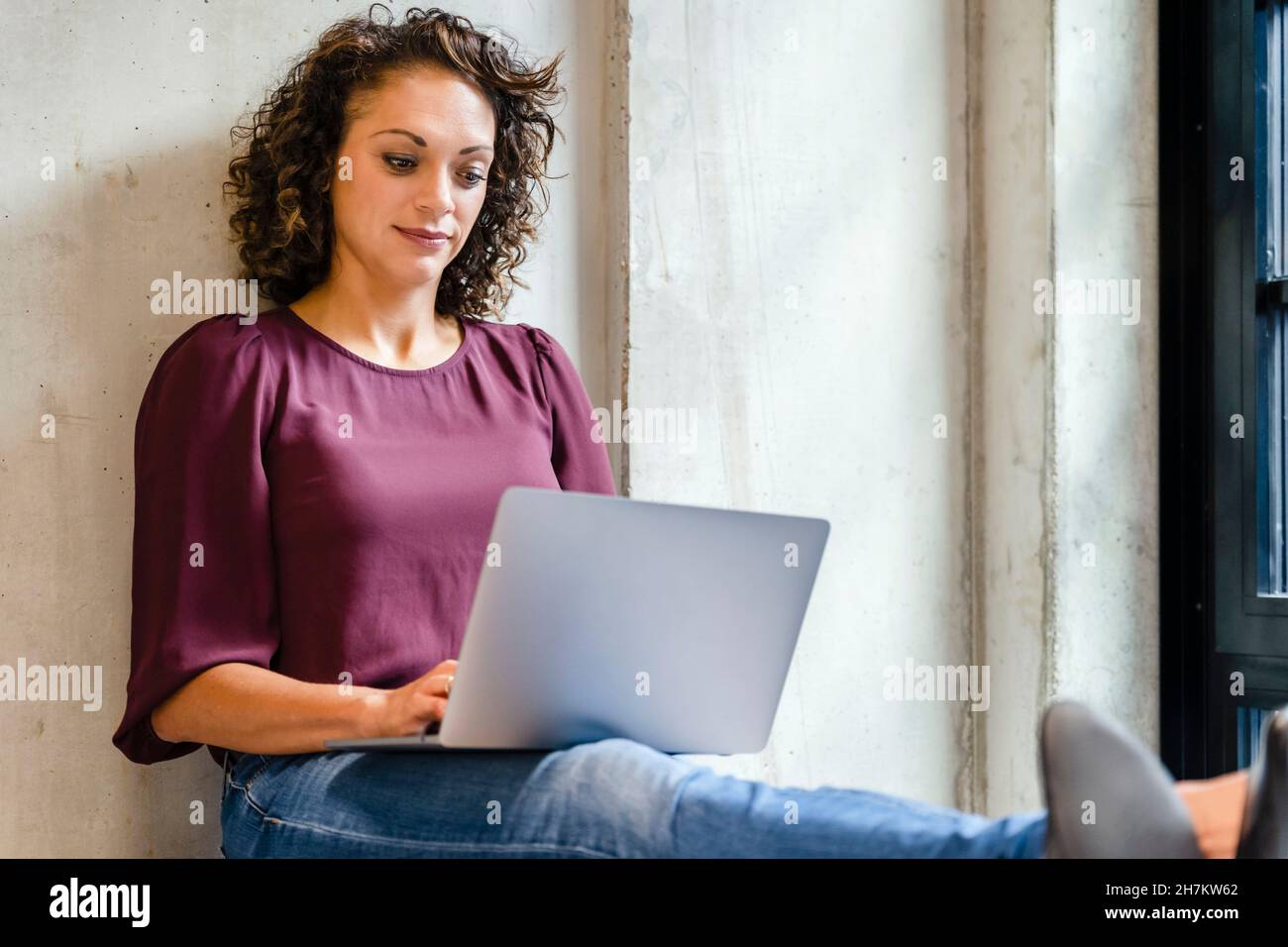 Female entrepreneur using laptop while working in office Stock Photo ...