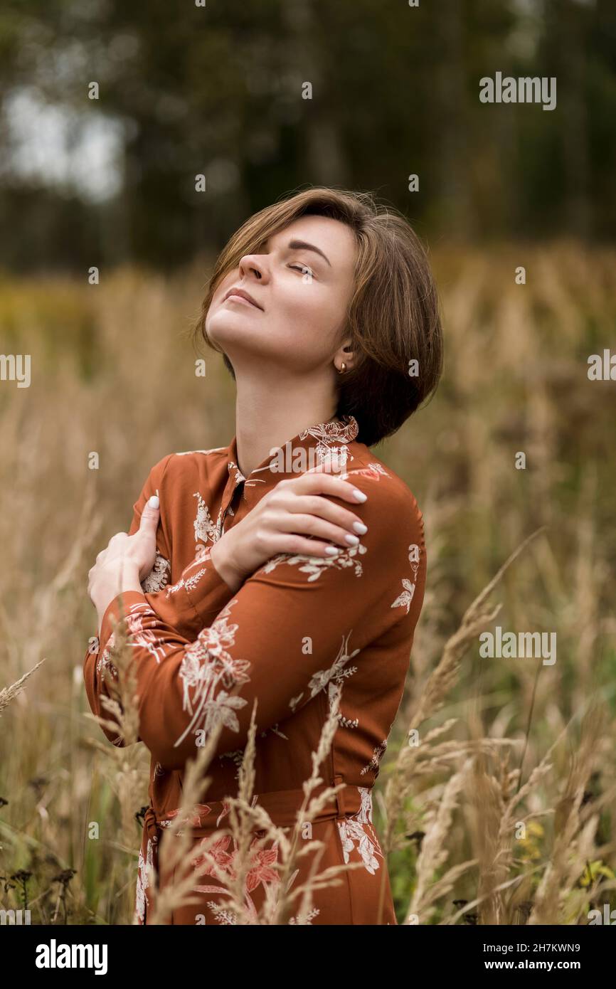 Woman hugging herself outdoors hi-res stock photography and images - Alamy
