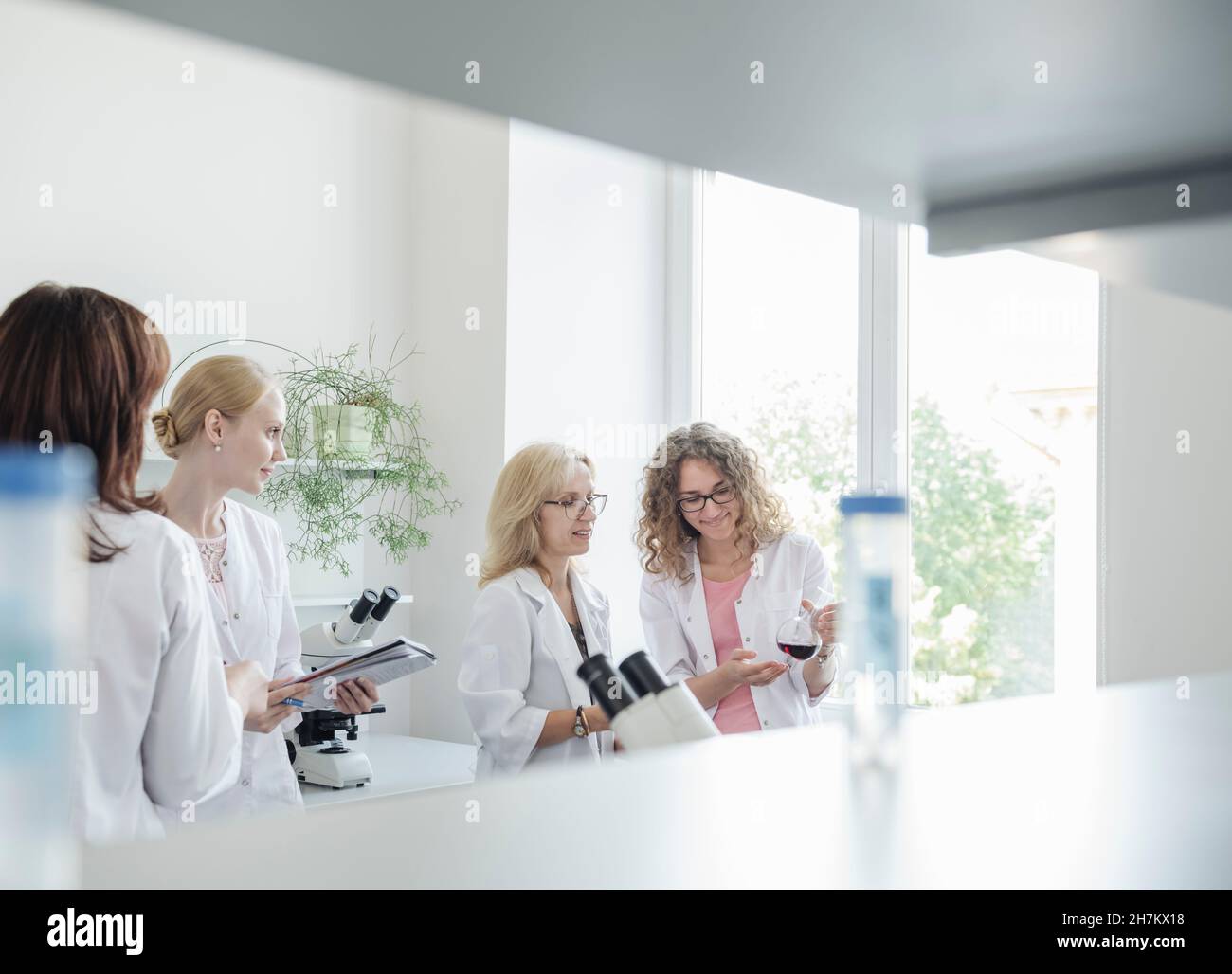 Researchers discussing sample in laboratory Stock Photo - Alamy