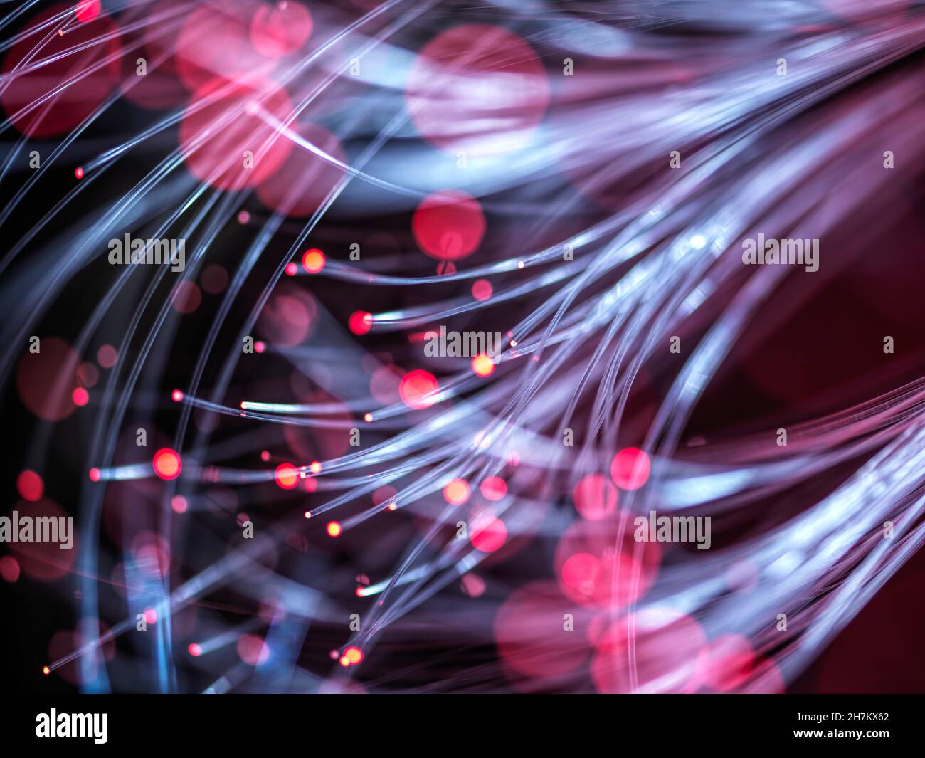 Illuminated red fiber optics carrying data Stock Photo - Alamy