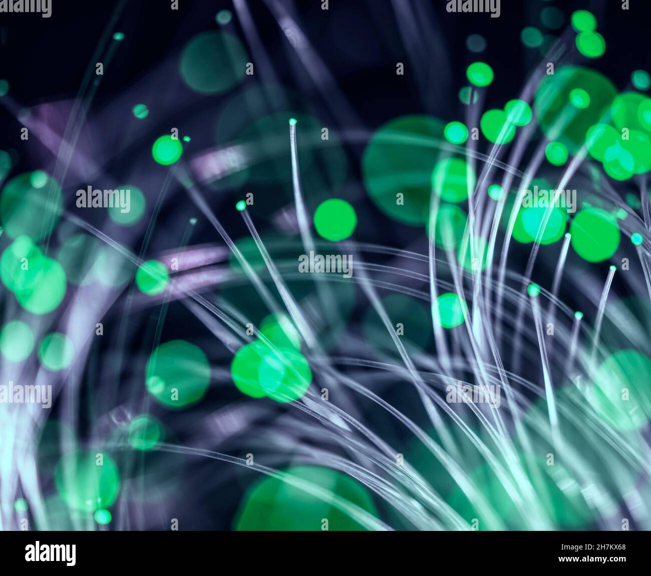 Glowing green fiber optics against black background Stock Photo - Alamy