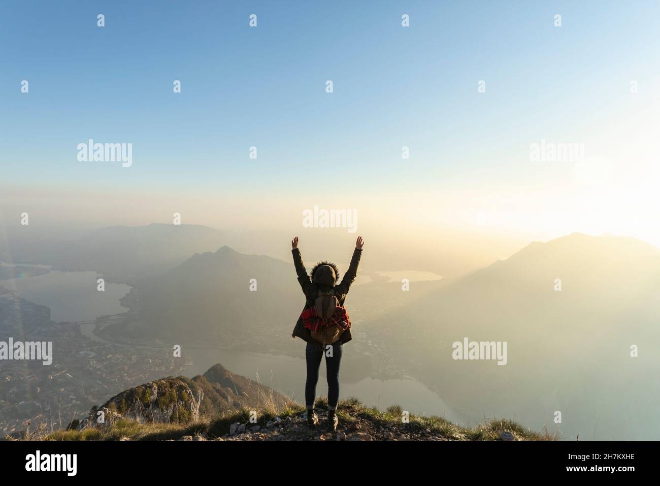 Female hiker with arms raised on mountain peak at Orobie Alps, Lecco ...