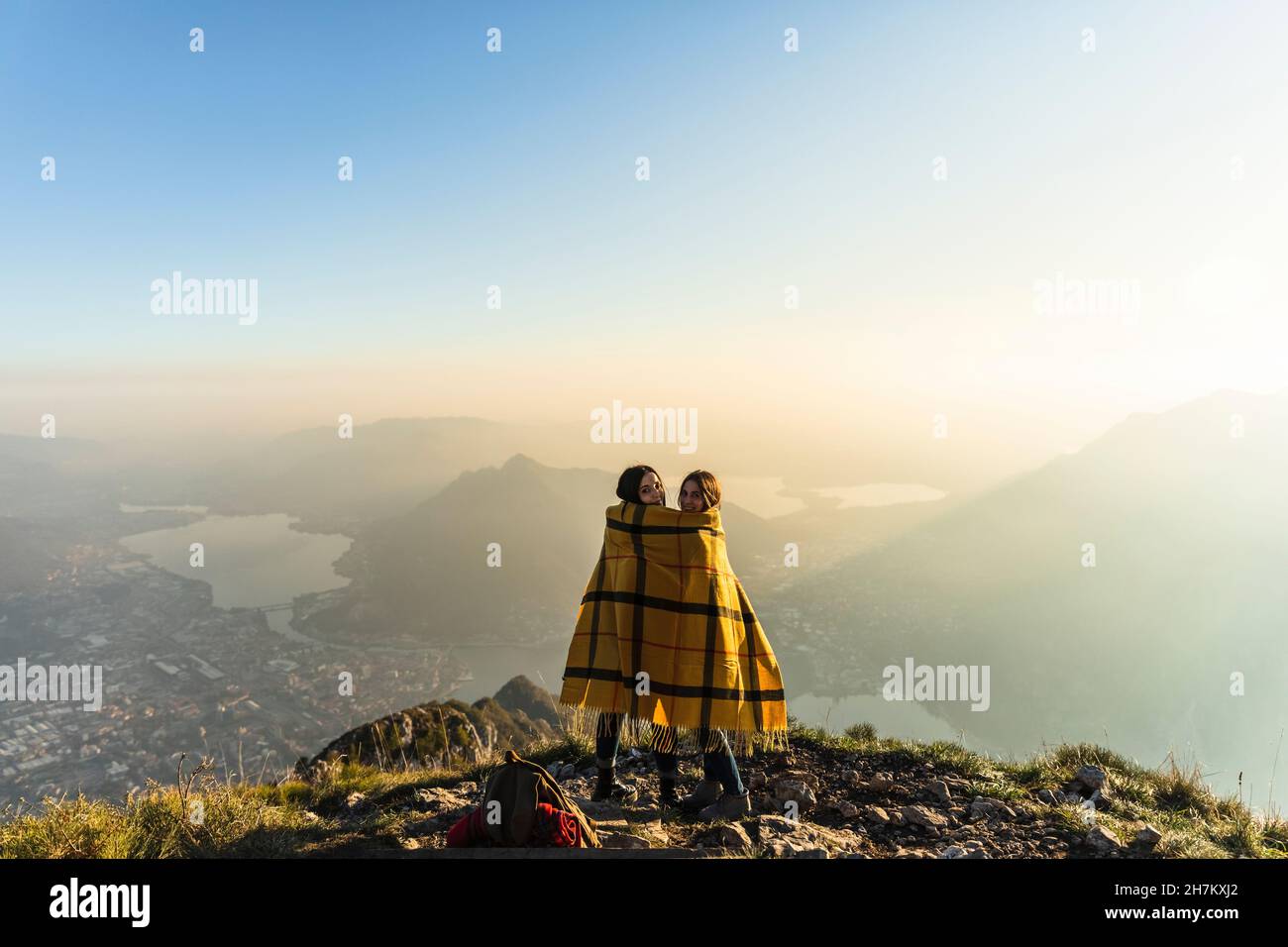 Women wrapped blanket looking over shoulder mountain peak lecco hi-res ...