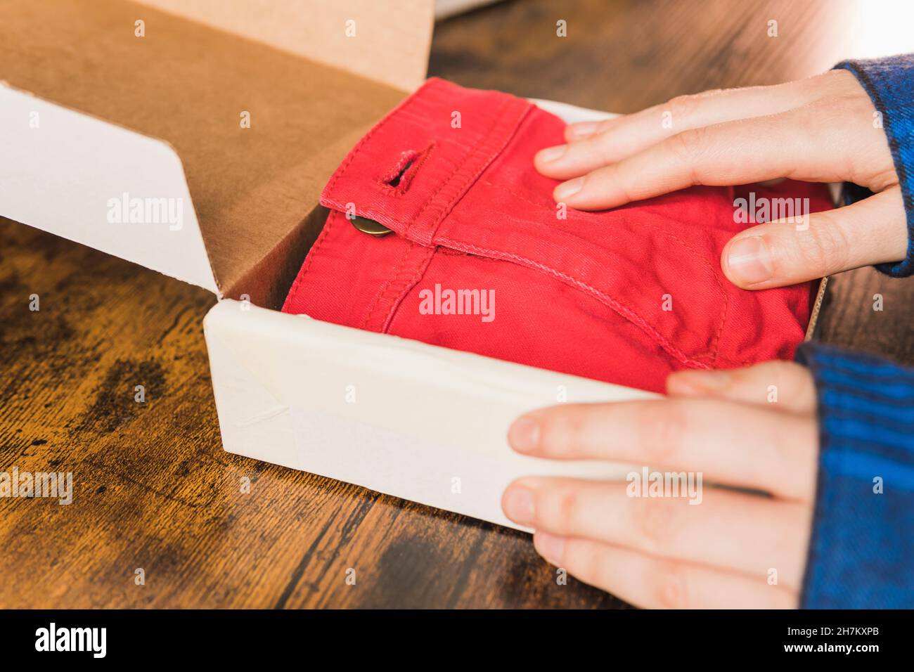 Female fashion designer packing clothes in box at studio Stock Photo ...