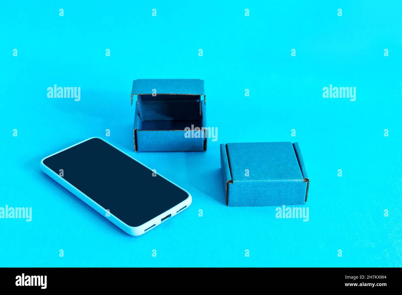 Smartphone with a blank screen and blue boxes on a light blue ...
