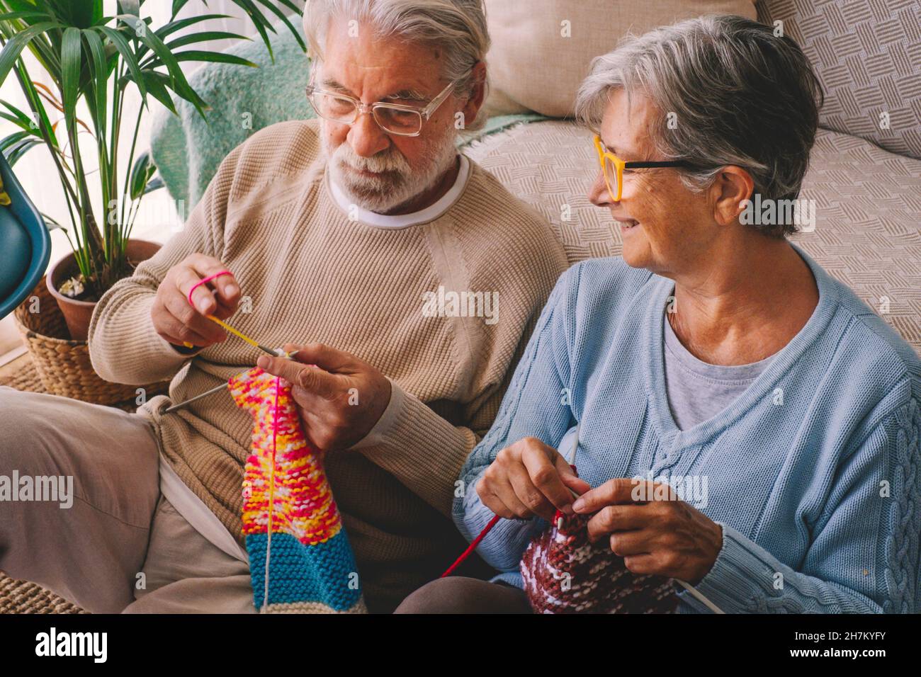 Couple knitting wool in living room Stock Photo - Alamy