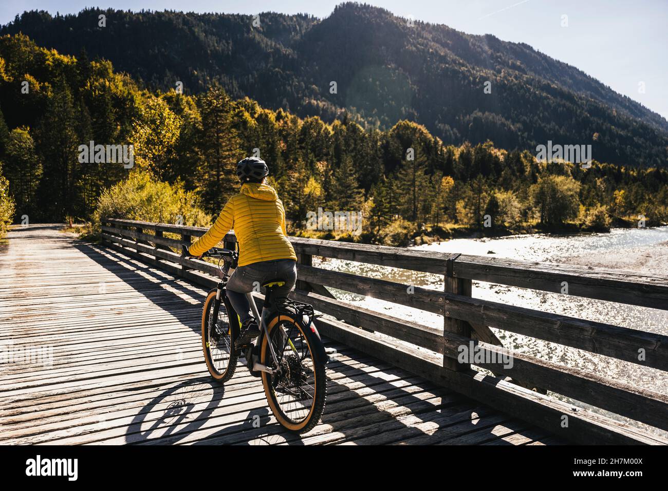 Woman riding mountain bike on bridge Stock Photo - Alamy