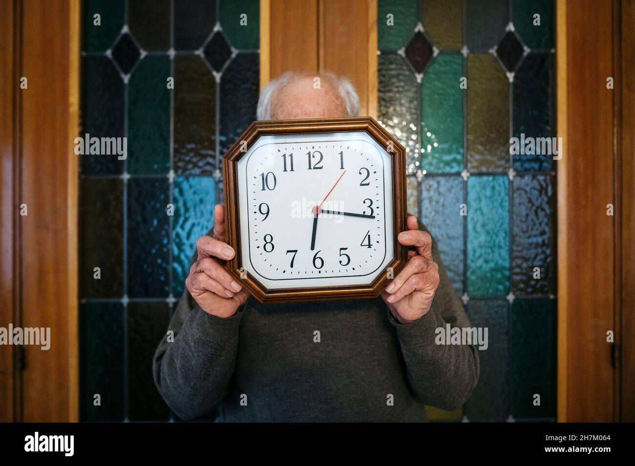 Man with clock hi-res stock photography and images - Alamy
