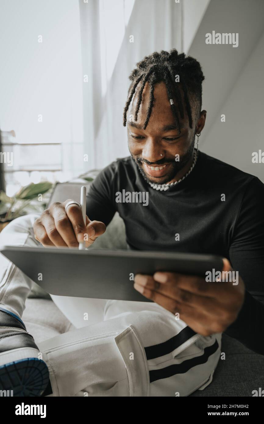 Young african man using tablet hi-res stock photography and images - Alamy