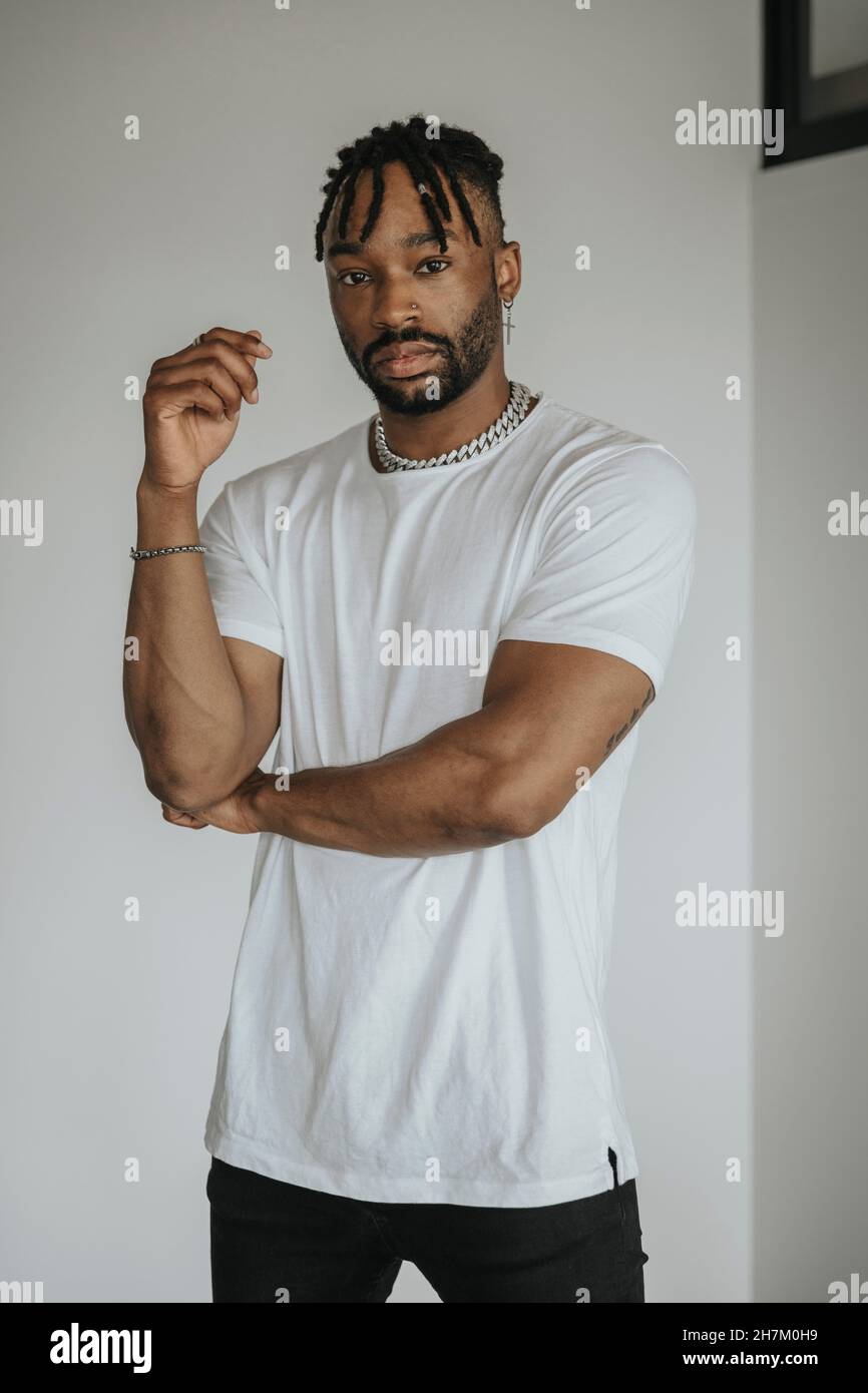 Young man standing front wall hi-res stock photography and images - Alamy