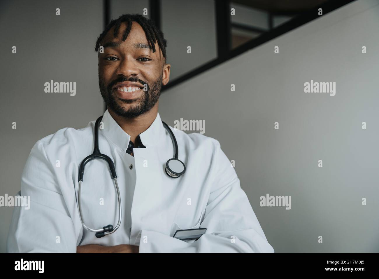 Bearded doctor with arms crossed at office Stock Photo - Alamy
