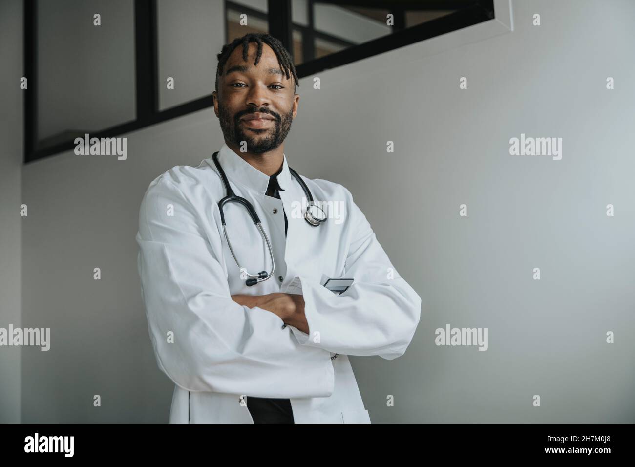 Confident doctor with arms crossed in office Stock Photo - Alamy