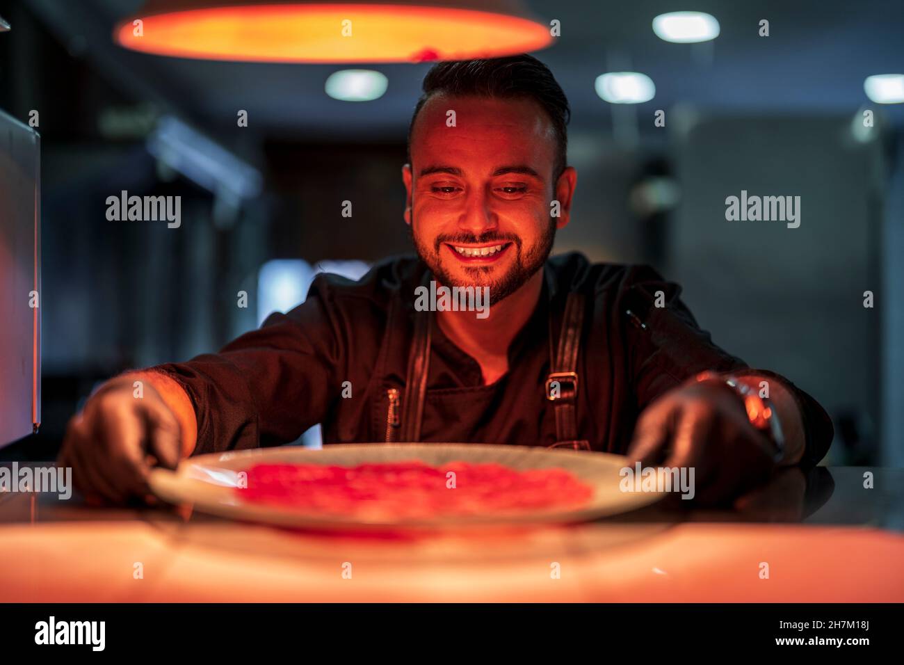 Chef holding plate smiling hi-res stock photography and images - Alamy