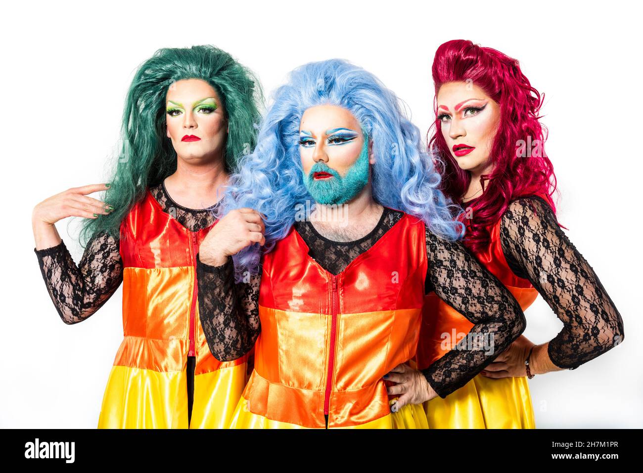Drag queens taking selfies through smart phones against yellow ...