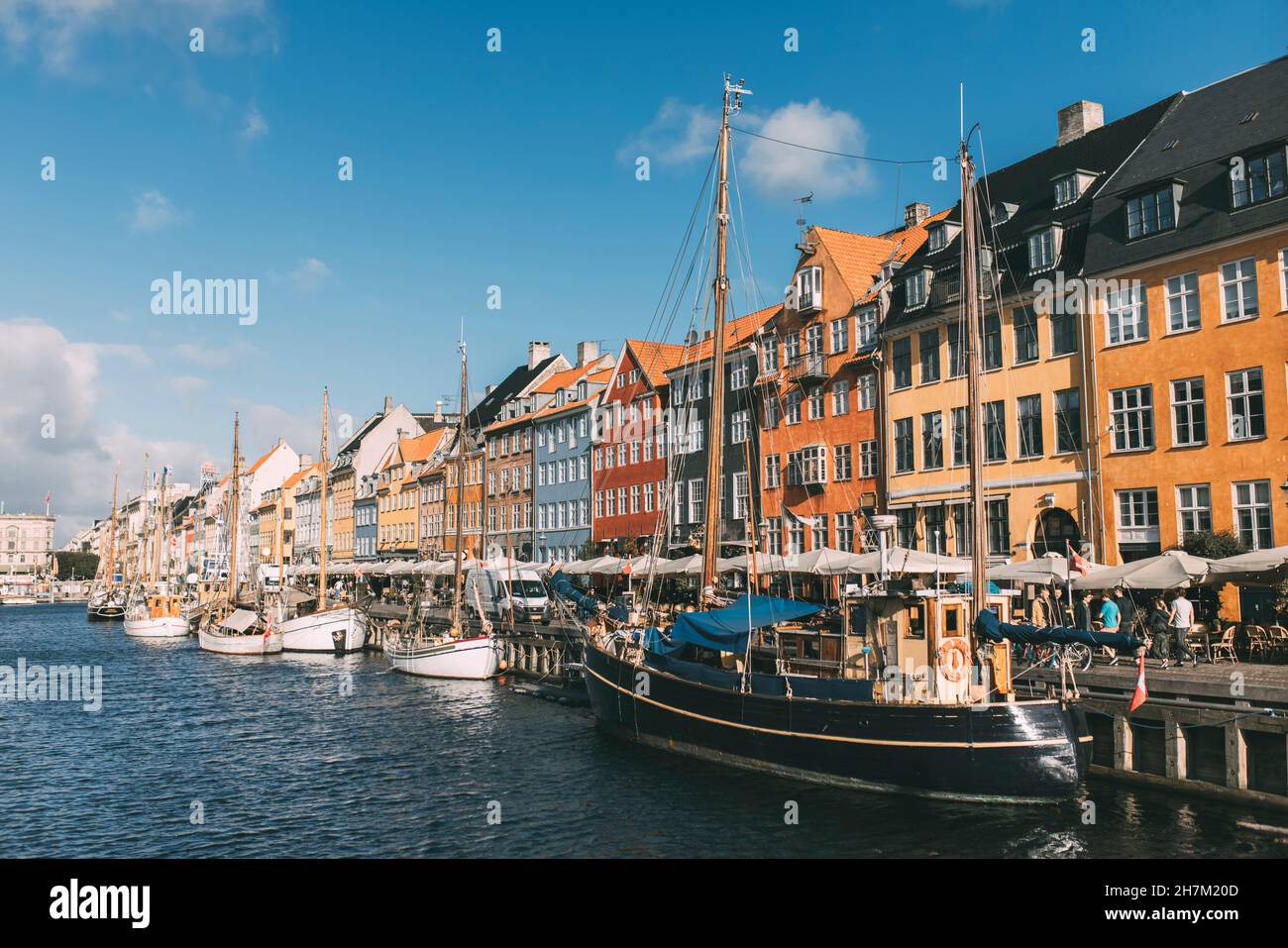 Boats moored at harbor on sunny day, Nyhavn, Copenhagen, Denmark Stock ...