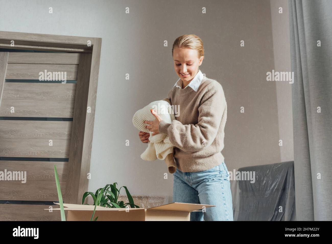 Woman Unpacking Moving Cardboard Box Hi Res Stock Photography And