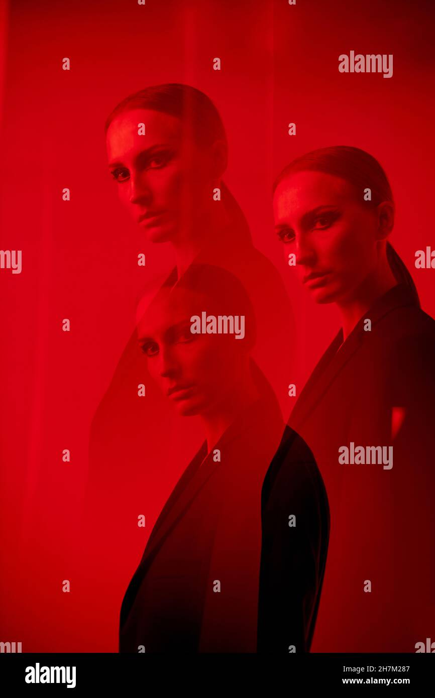 Multiple exposure fashion model standing red light Stock Photo - Alamy