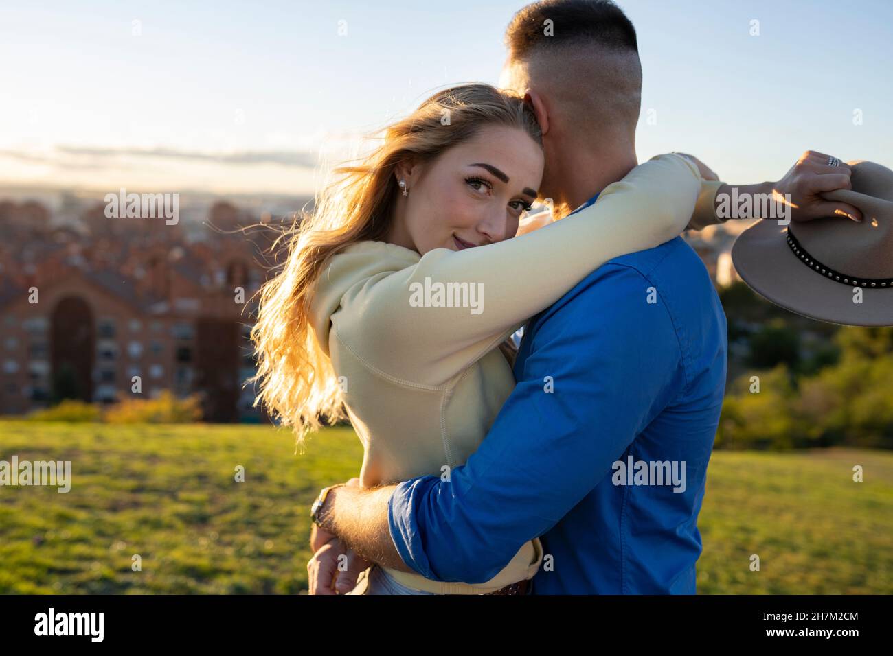 Boyfriend hugging girlfriend on hill Stock Photo - Alamy