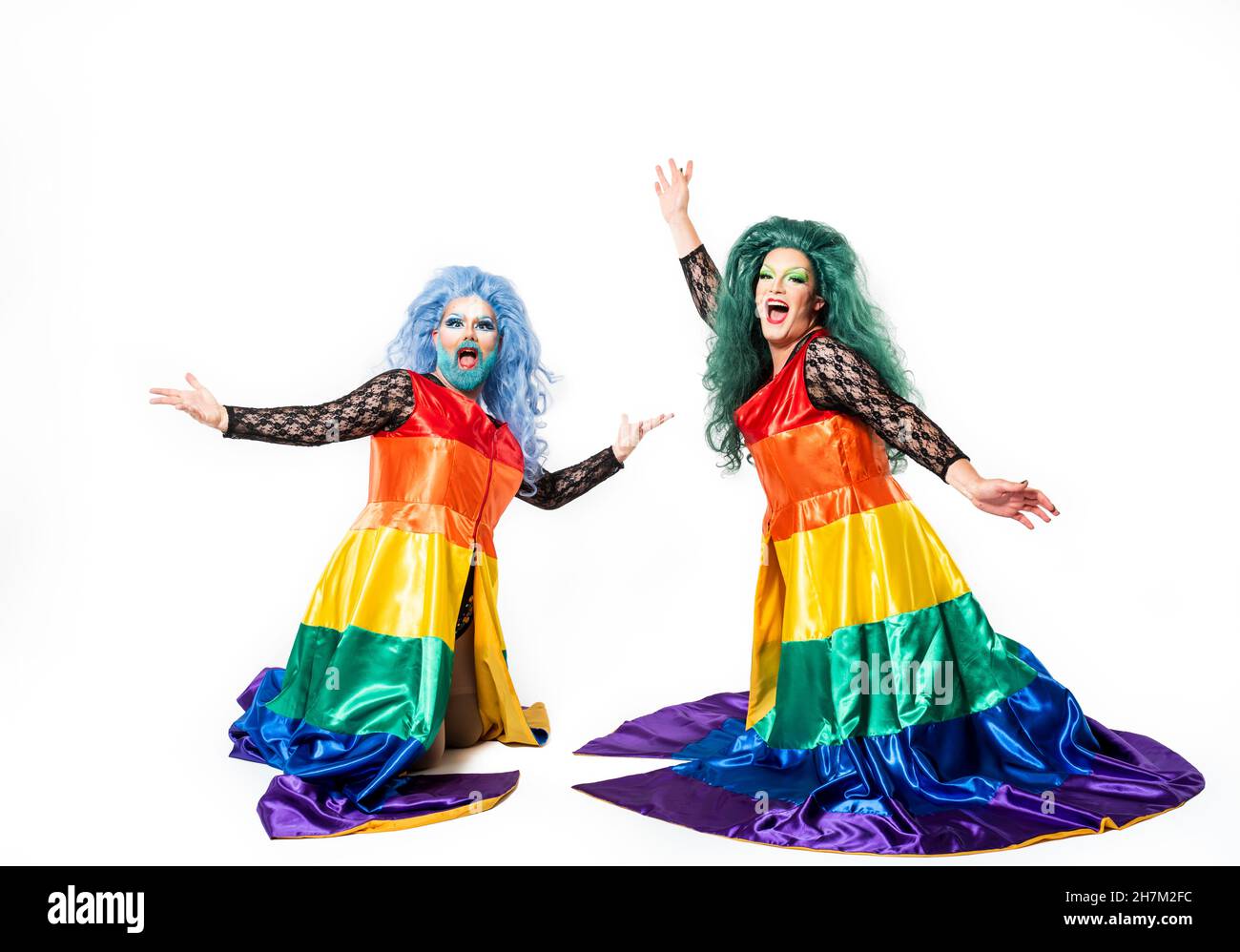 Drag queens with rainbow dresses standing over white background Stock ...