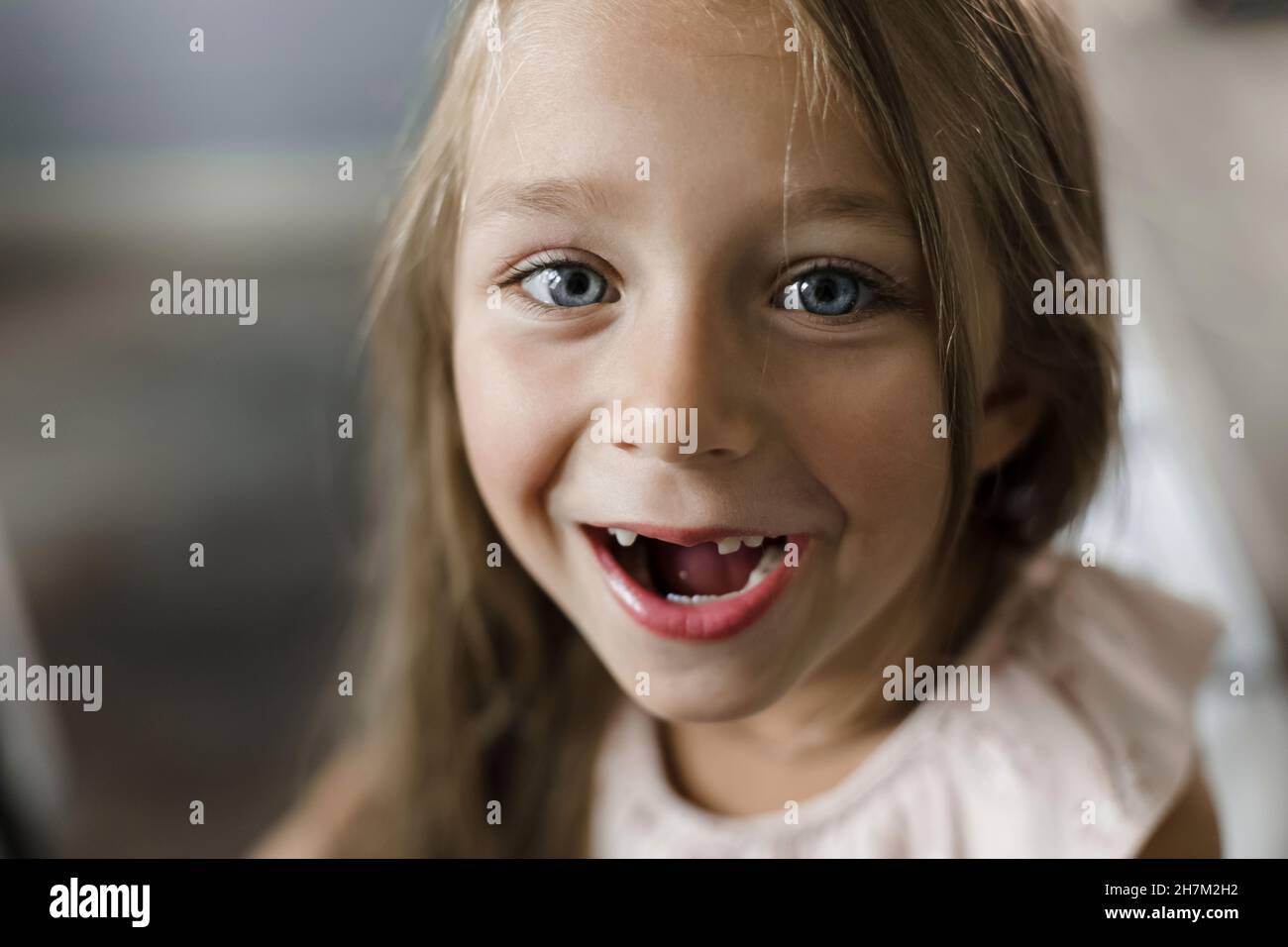 Girl smiling with gap tooth at home Stock Photo - Alamy