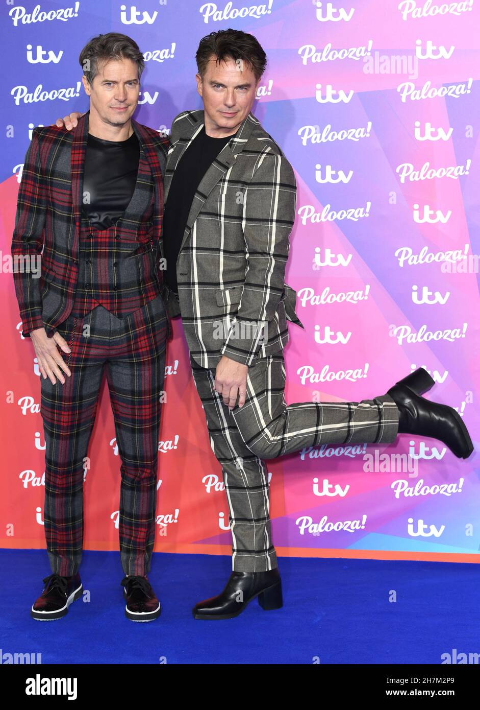 November 23rd, 2021, London, UK. Scott Gill and John Barrowman arriving ...