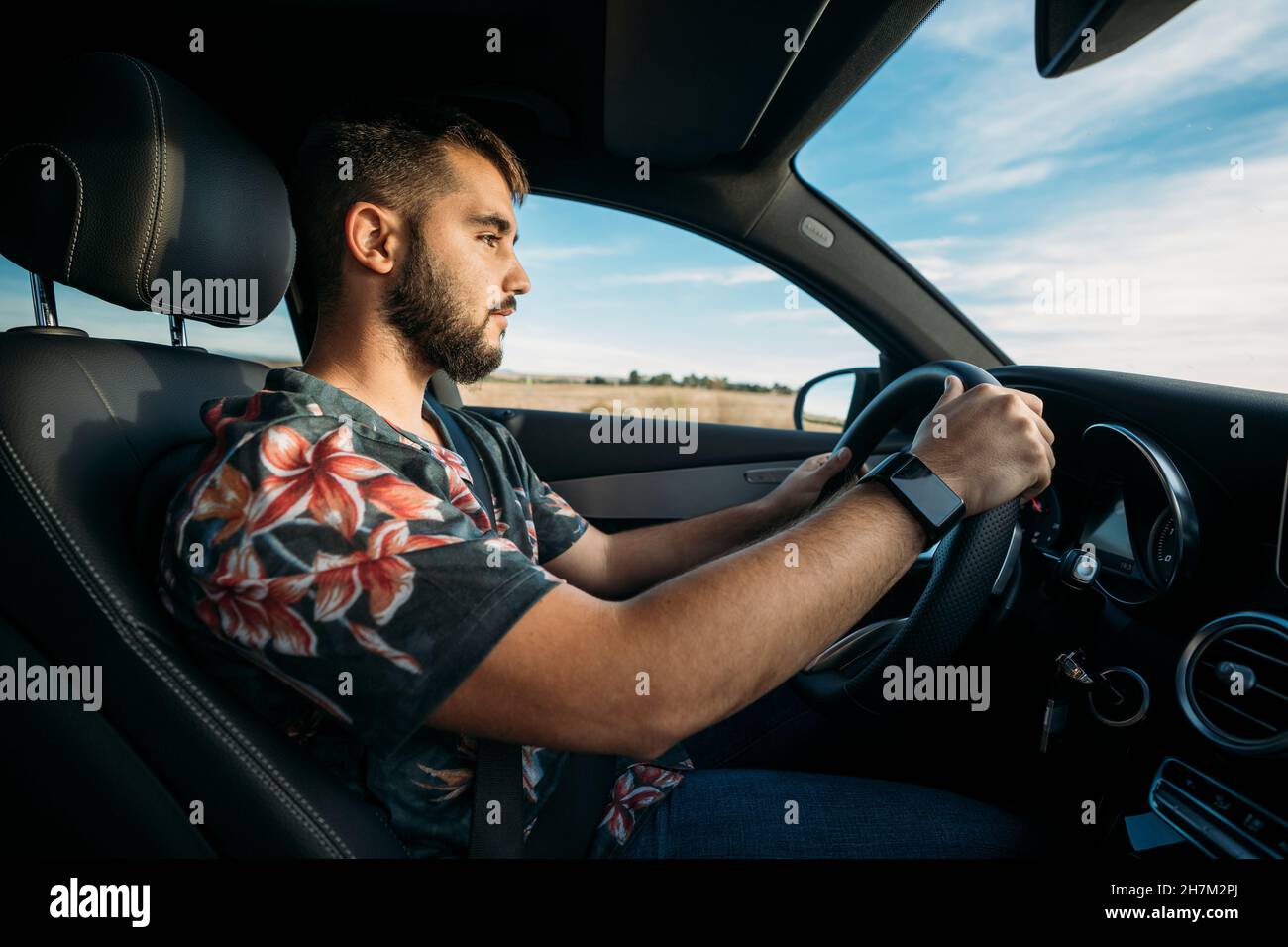 Bearded young man driving car Stock Photo - Alamy