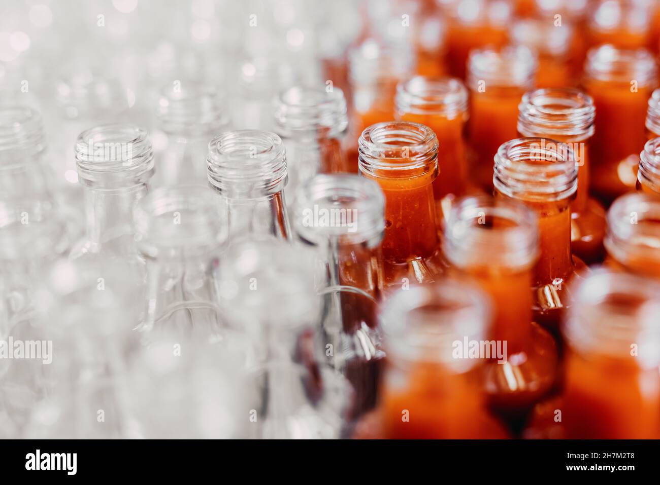 Empty and full chili sauce bottles in factory Stock Photo - Alamy