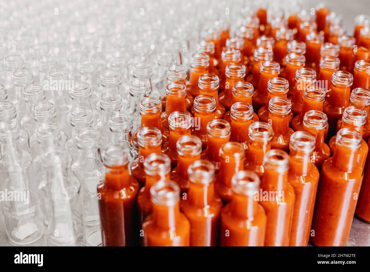 Empty and full red chili sauce bottles arranged in factory Stock Photo ...