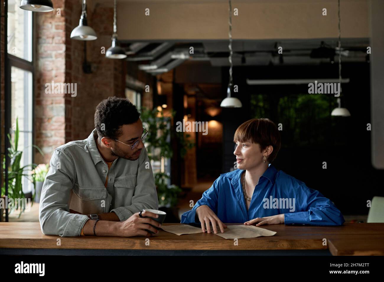 University students talking over document in cafe Stock Photo - Alamy