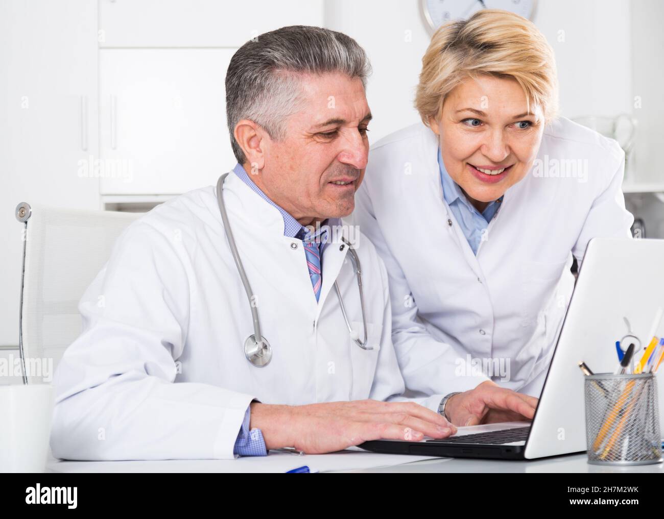 Doctor and nurse reading information Stock Photo - Alamy