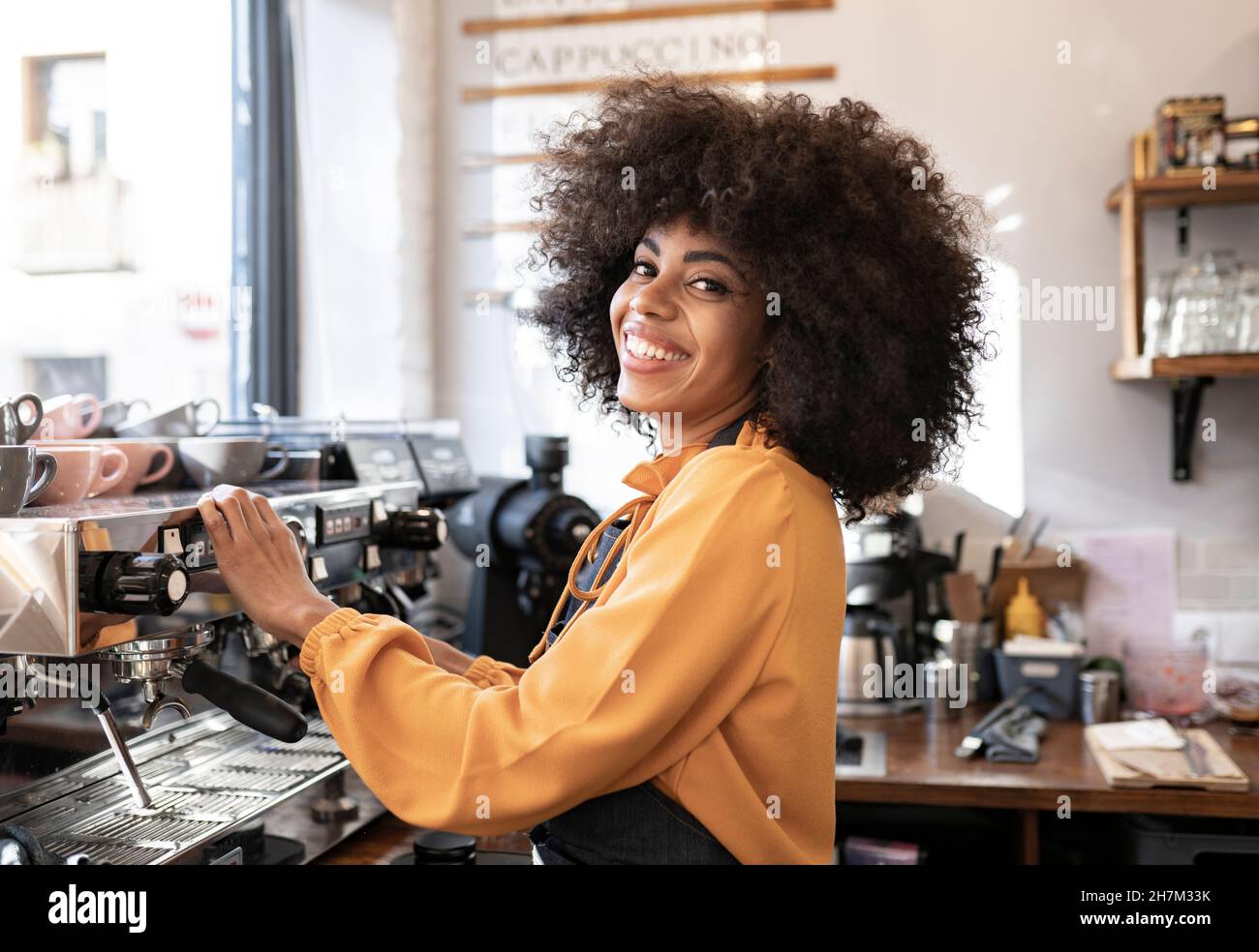 Smiling waitress showing check mark card reader screen in cafe Stock ...