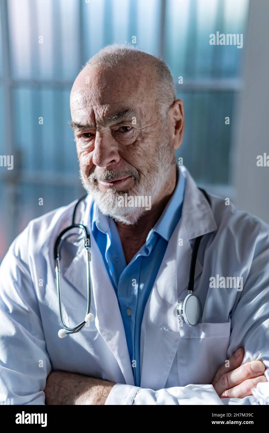 Serious doctor arms crossed standing hi-res stock photography and ...