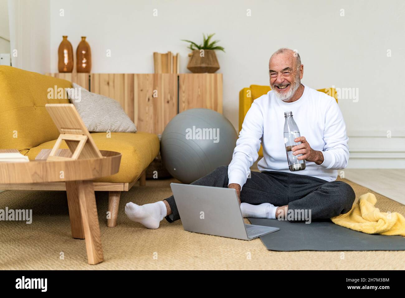 Senior man watching tutorial on laptop at home Stock Photo - Alamy