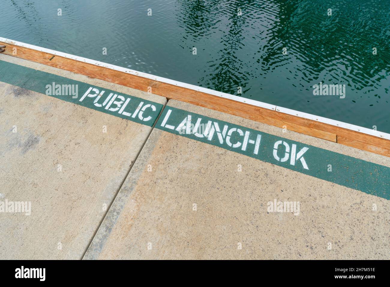 Public launch ok painted sign on a concrete dock in Oceanside ...