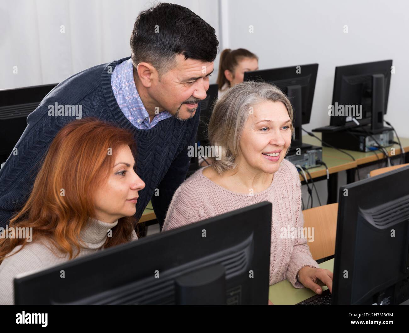 Mature people working together on computer Stock Photo - Alamy