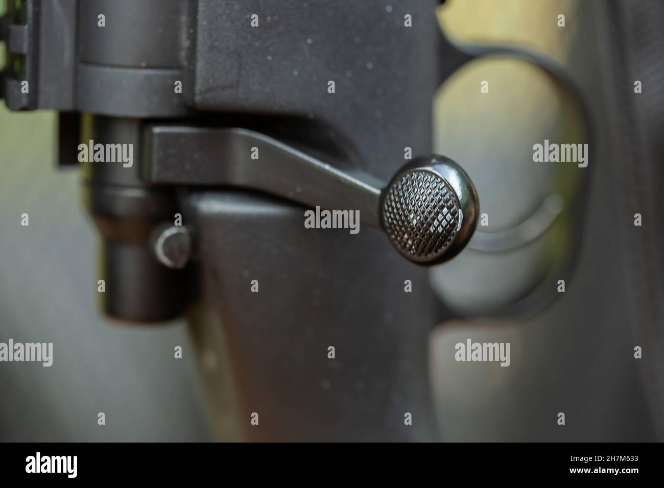 Close-up of parts of automatic weapon with selective focus and blurred ...