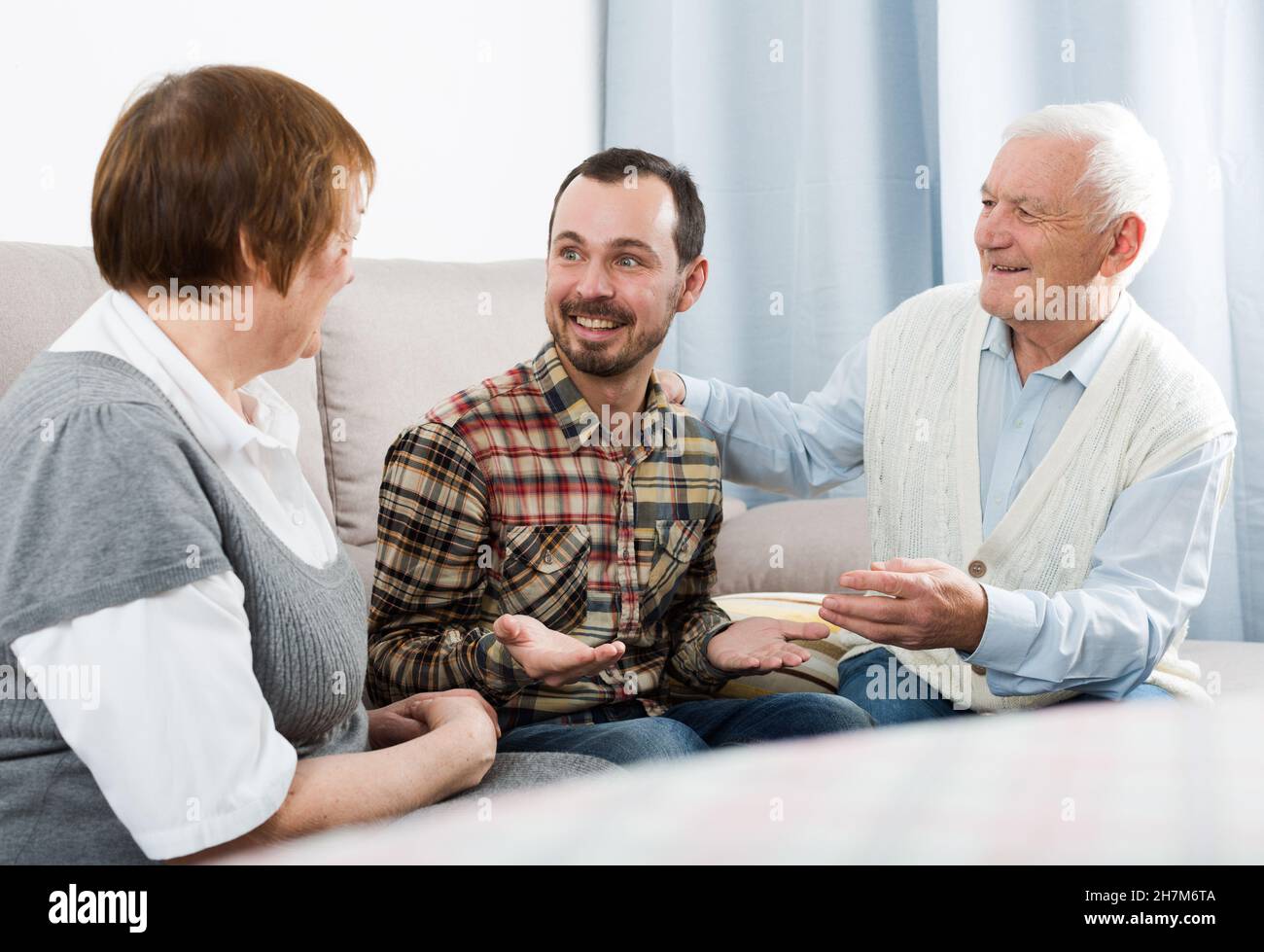 Parents and son enjoying evening Stock Photo - Alamy