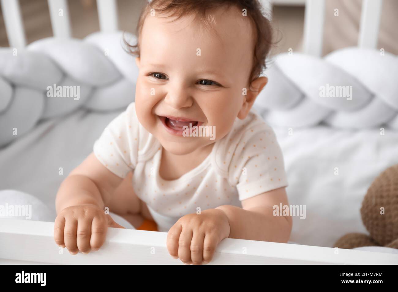 Cute little baby in crib Stock Photo - Alamy