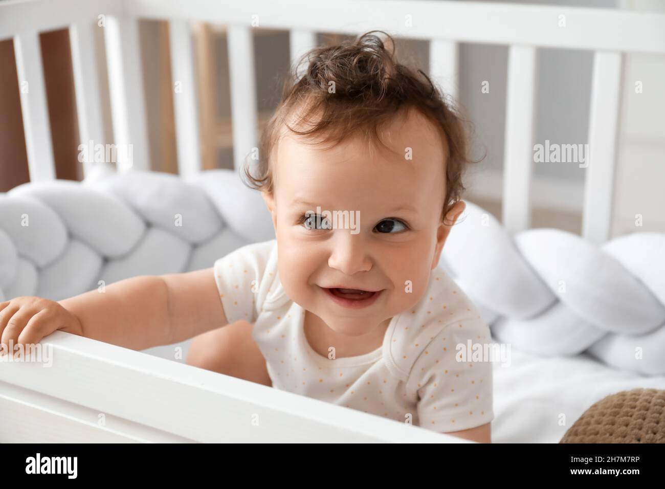 Cute little baby in crib Stock Photo - Alamy