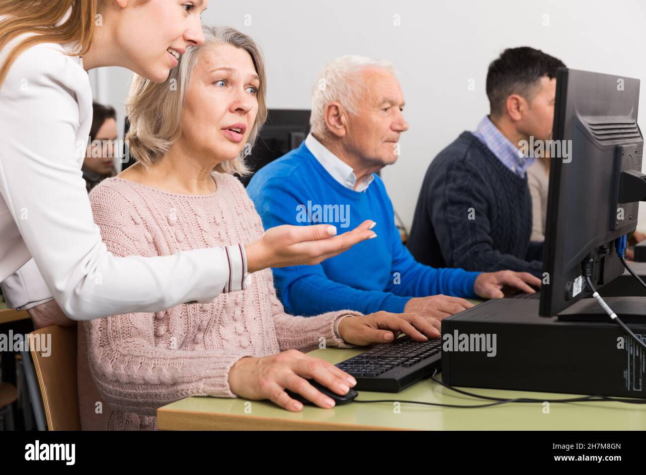 Side view of young business woman explaining something to older ...